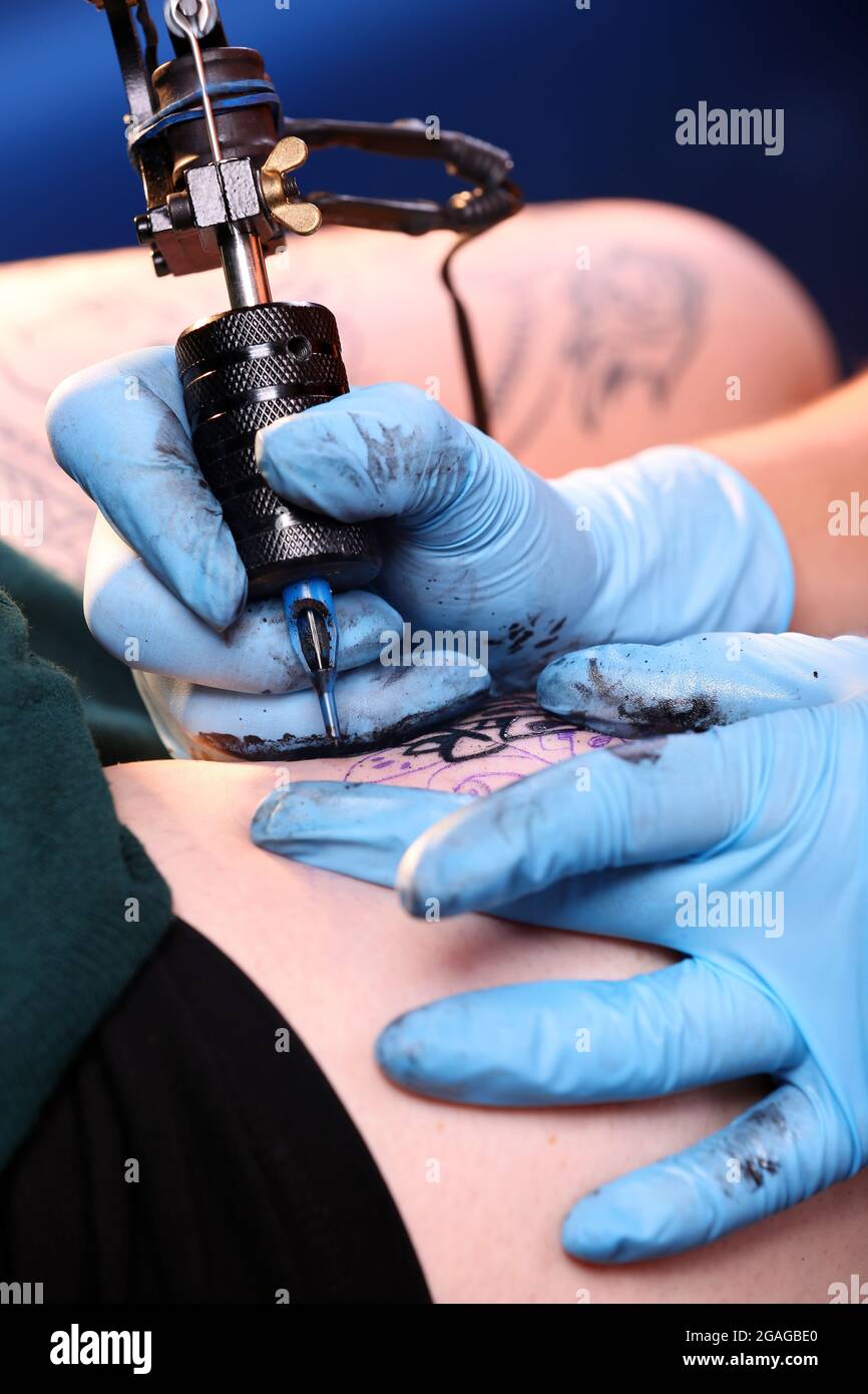 Process of making tattoo close-up Stock Photo - Alamy