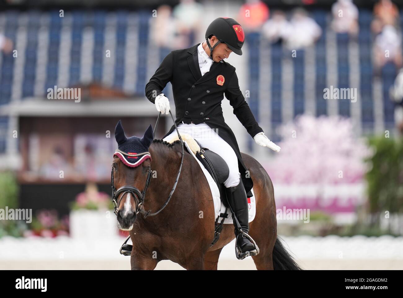 Tokyo, Japan. 31st July, 2021. Bao Yingfeng of China pats his horse ...