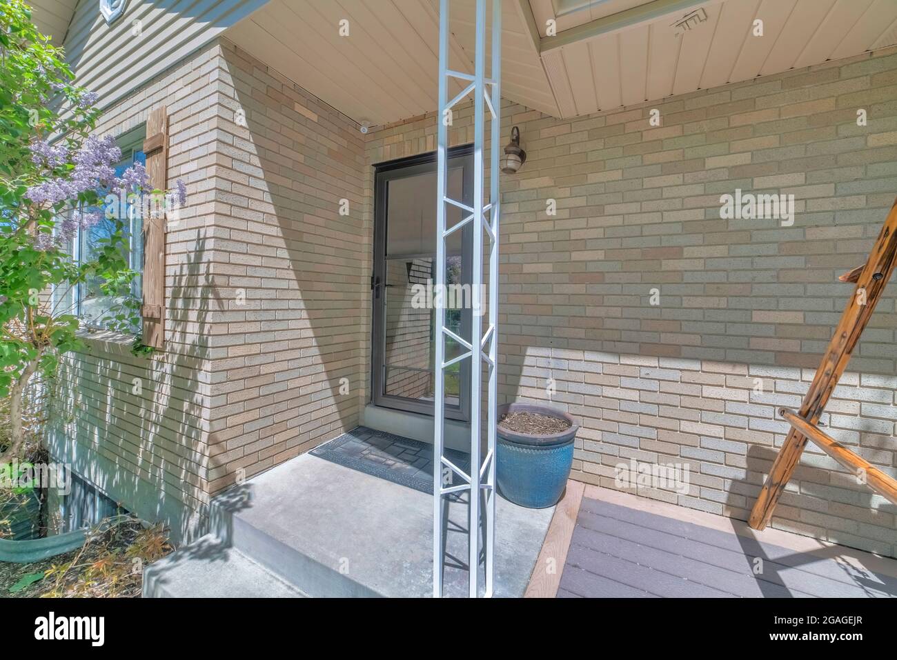 Exterior of a home with storm door and a bricks siding Stock Photo - Alamy