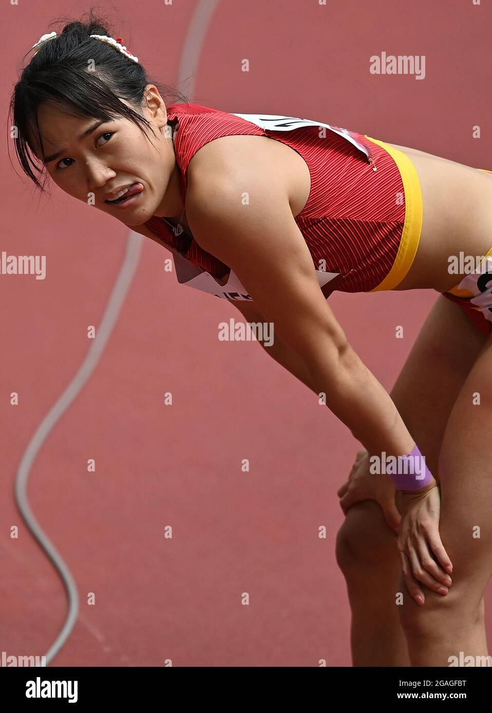 Tokyo, Japan. 31st July, 2021. Chen Jiamin of China reacts after the women's 100m hurdles heats ...