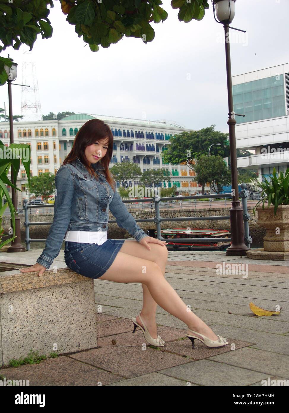 Asian Chinese Model Sitting by the Singapore River Stock Photo - Alamy