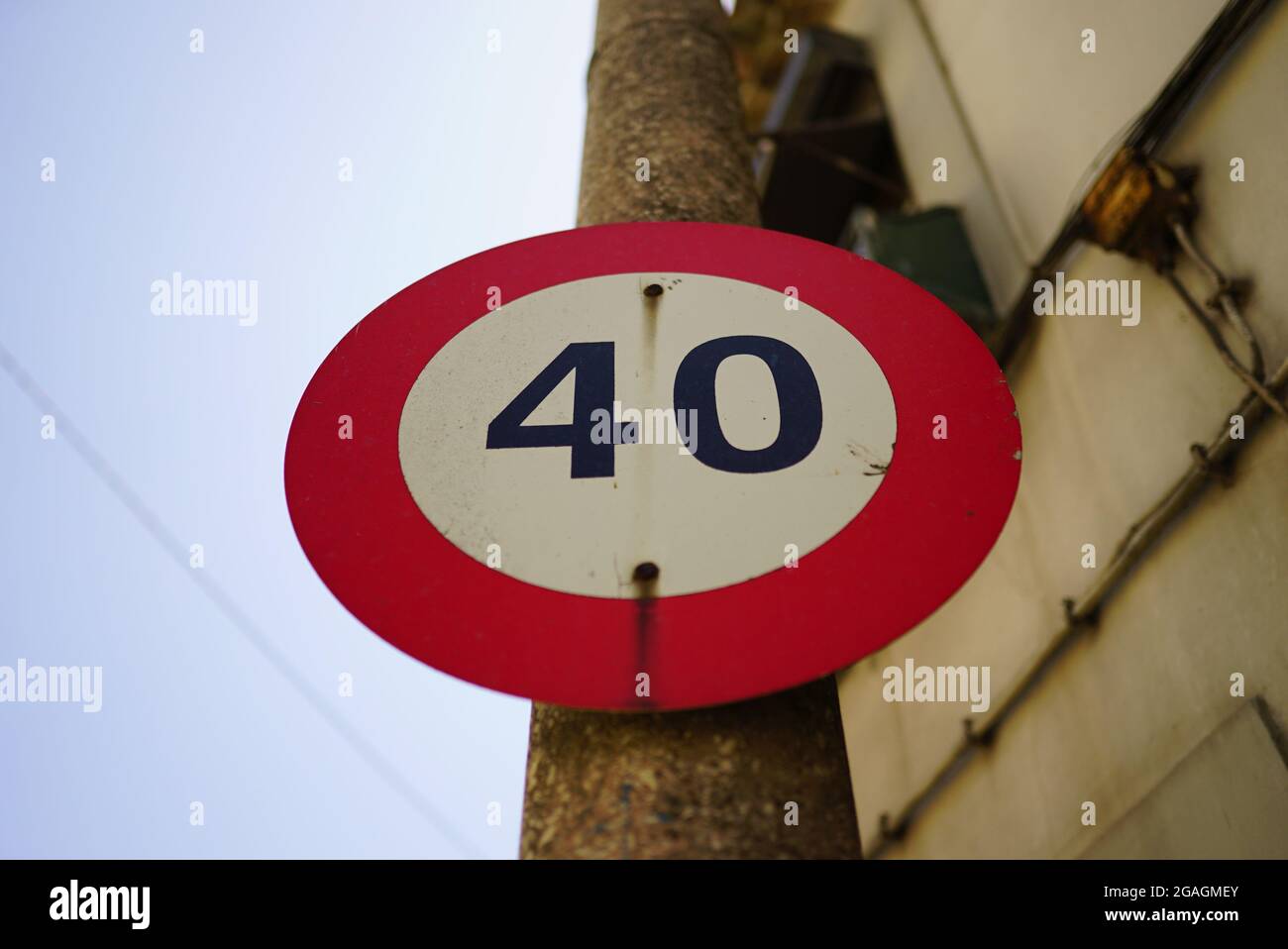Road sign mounted on a post indicating a 40 mph speed limit for ...