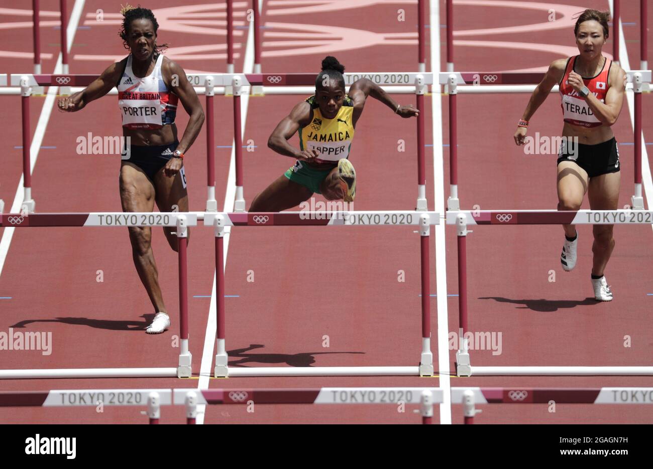Tokyo, Japan. 30th July, 2021. Jamaica's Megan Tapper (C) races to a ...