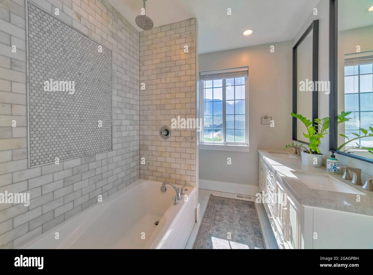 Luxurious bathroom interior with marble tiles and windows Stock Photo ...