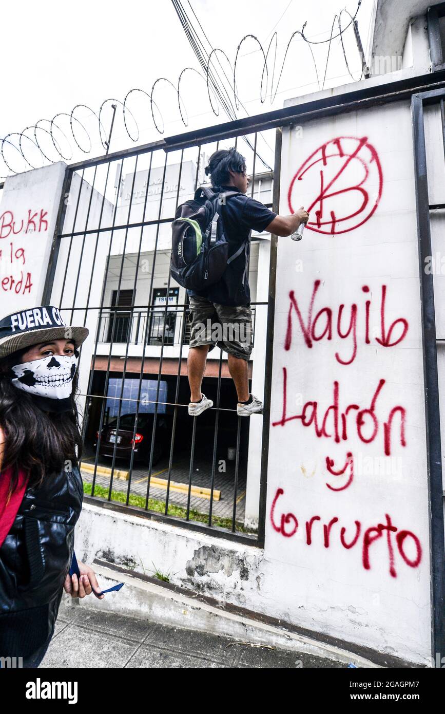 San Salvador, El Salvador. 30th July, 2021. A demonstrator spray paints ...