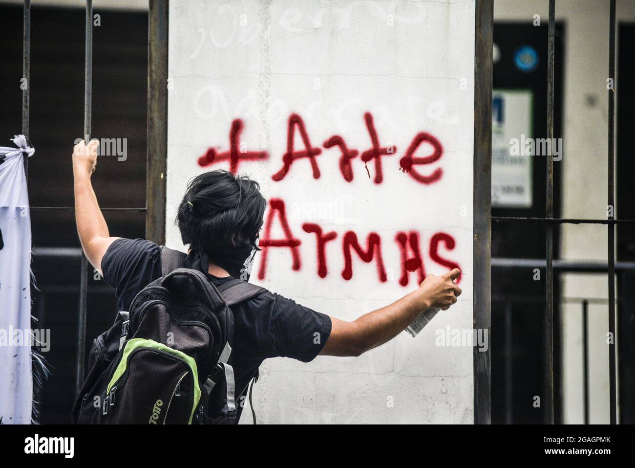 San Salvador, El Salvador. 30th July, 2021. A demonstrator spray paints ...