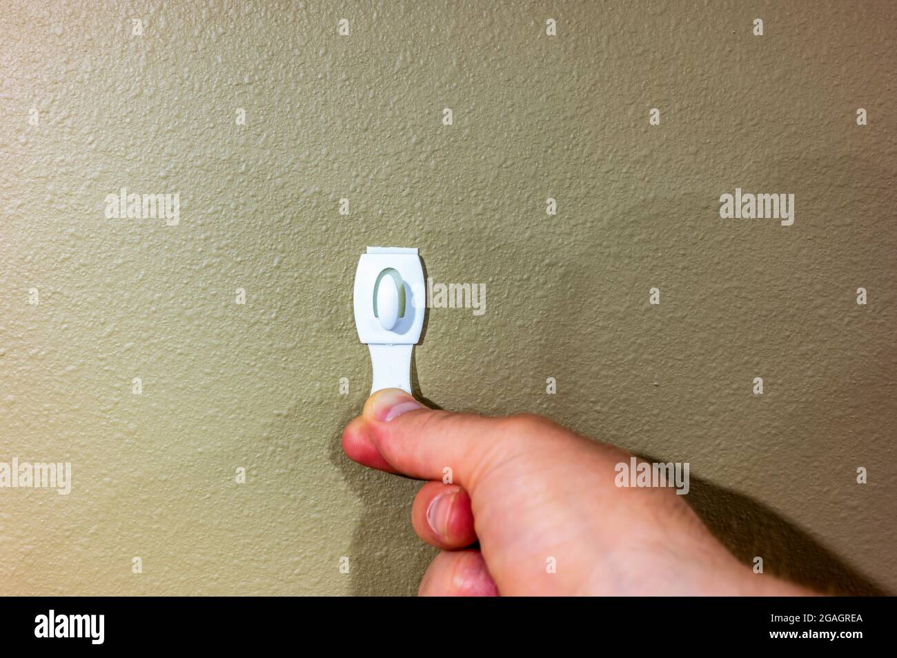 Selective focus on adhesive strip wall hanger that can be removed by ...