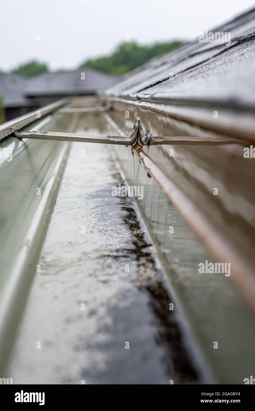 Selective focus on a section of residential guttering with hanger ...