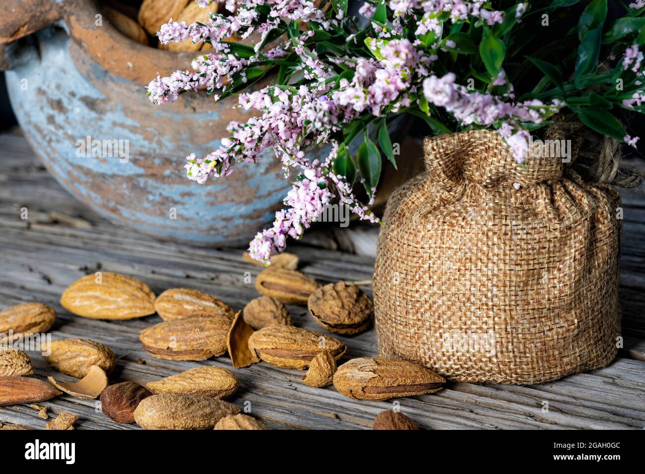 Still life. Almond nuts in a clay pot on a wooden table close up Stock ...
