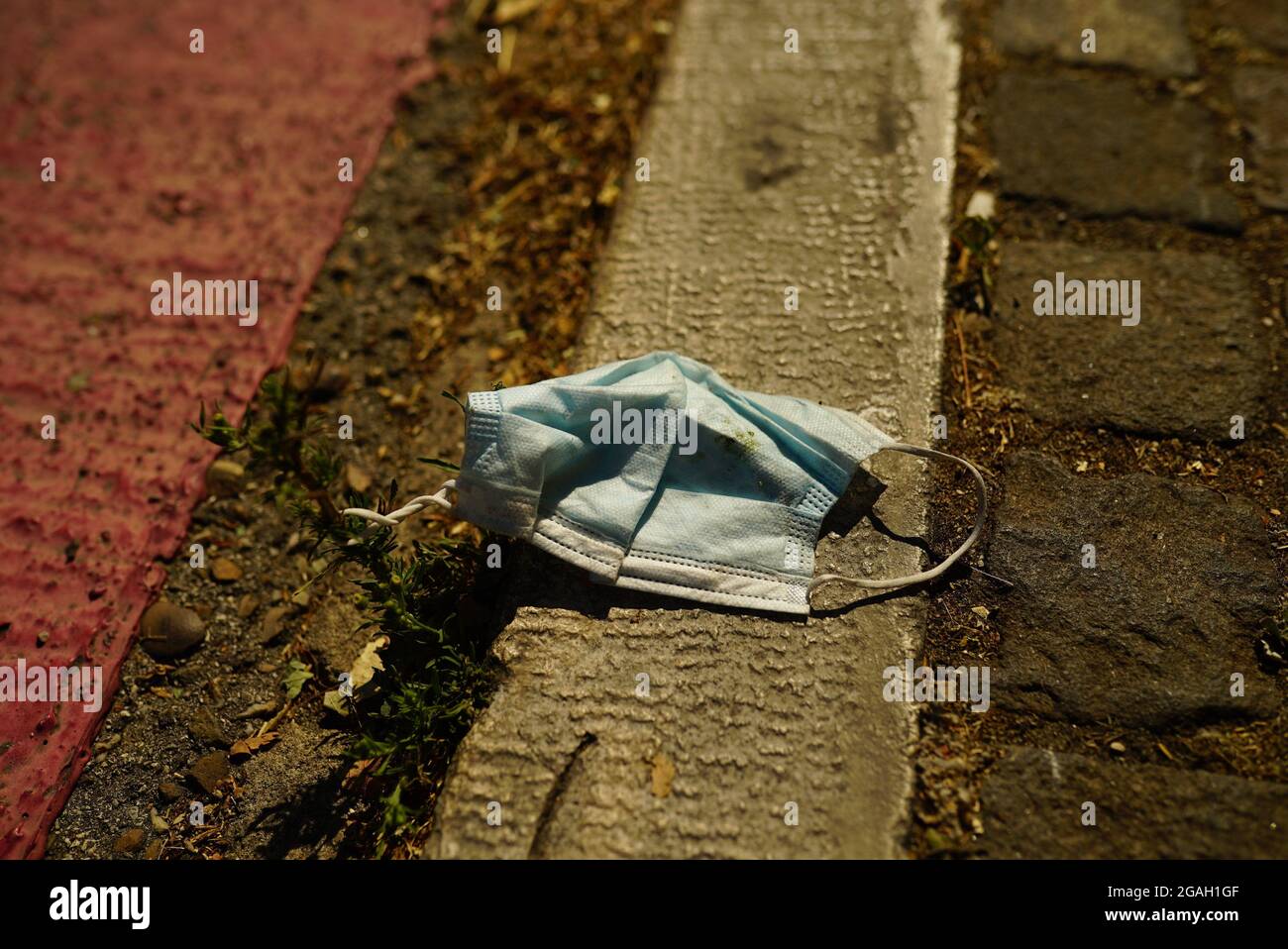 Closeup of medical facemask fallen on the ground Stock Photo - Alamy