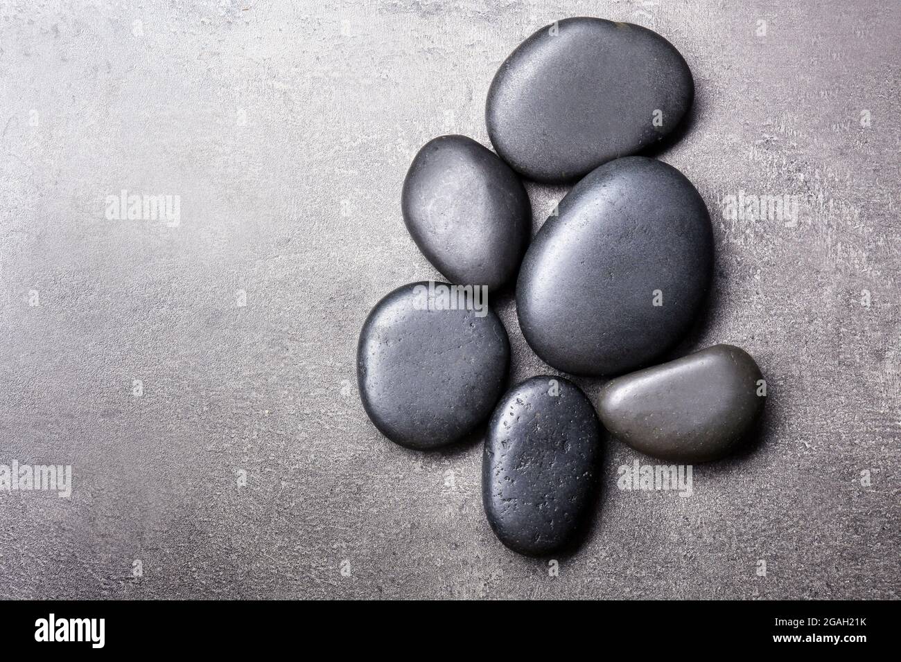 Group of pebbles on dark background Stock Photo - Alamy