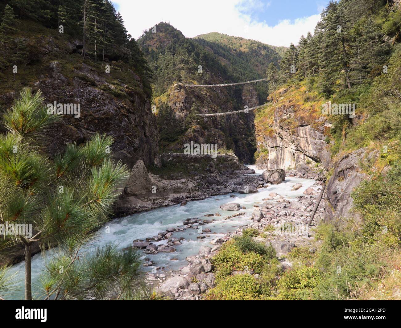 View of Dudh Koshi River, with twin suspension bridges in the ...
