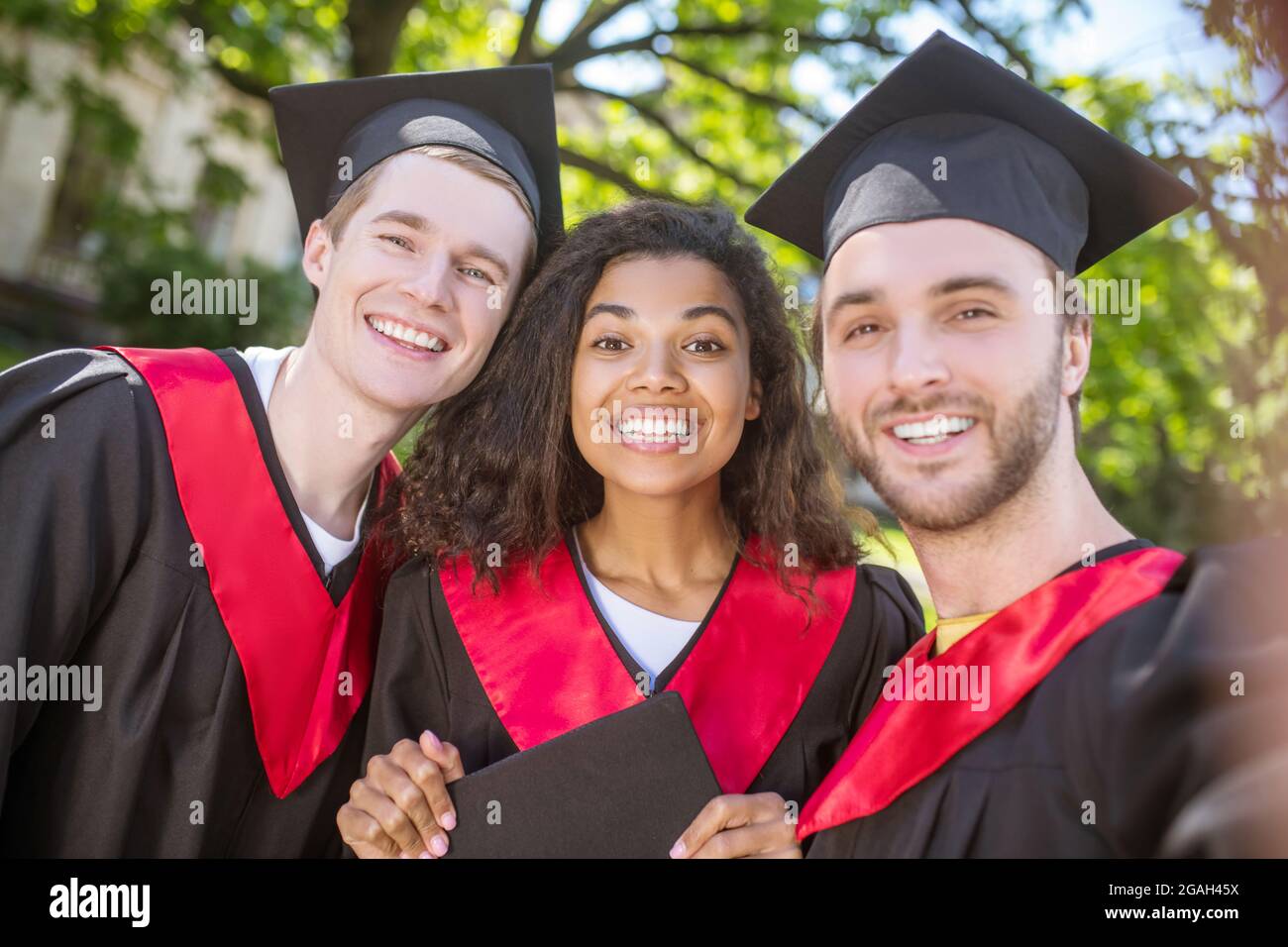 A group of graduates spending time together and feeling united Stock ...