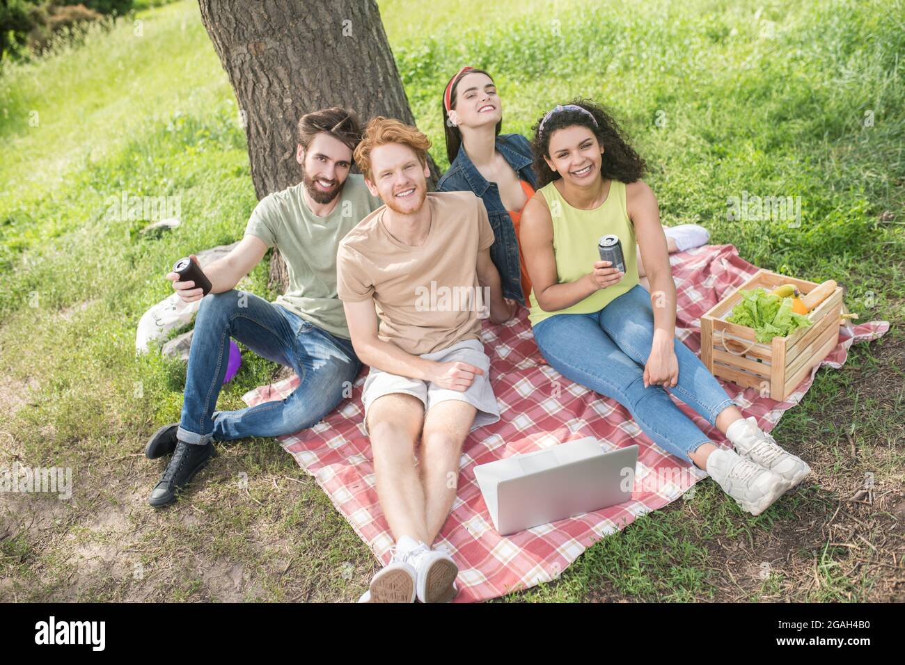 Top view of young people having rest under tree Stock Photo - Alamy