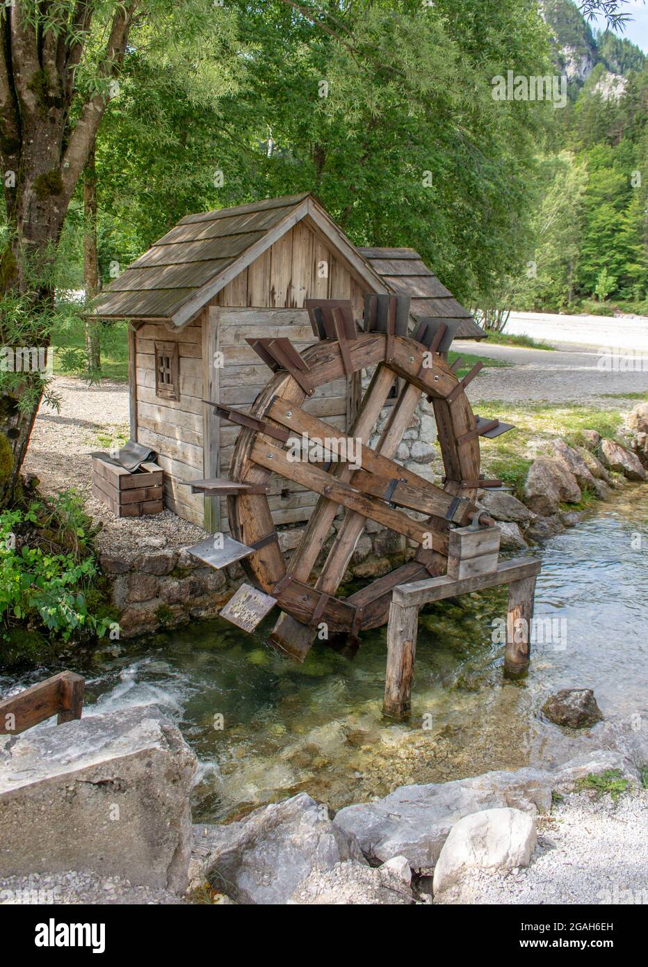 Wooden water wheel mill. Park and landscape design Stock Photo - Alamy