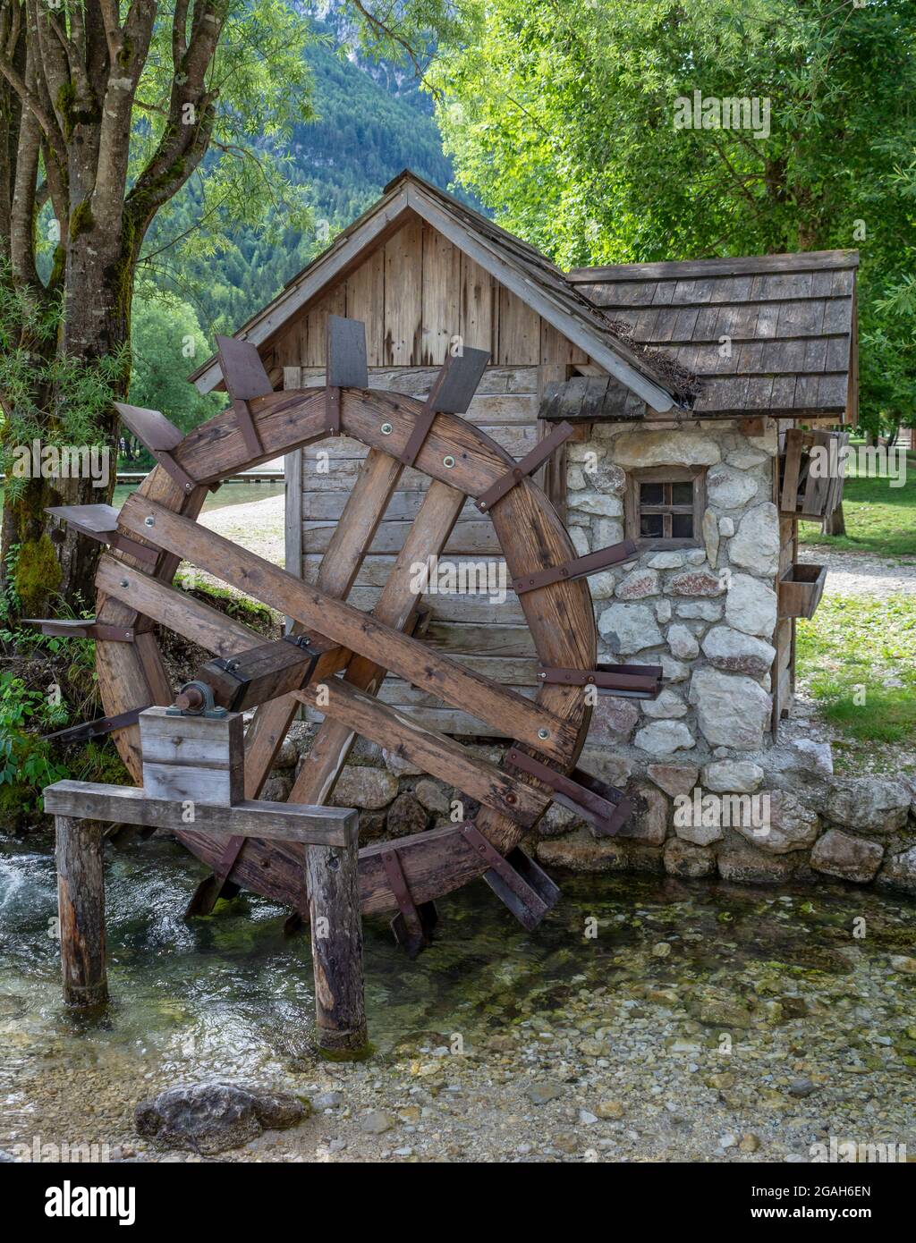 Wooden water wheel mill. Park and landscape design Stock Photo - Alamy