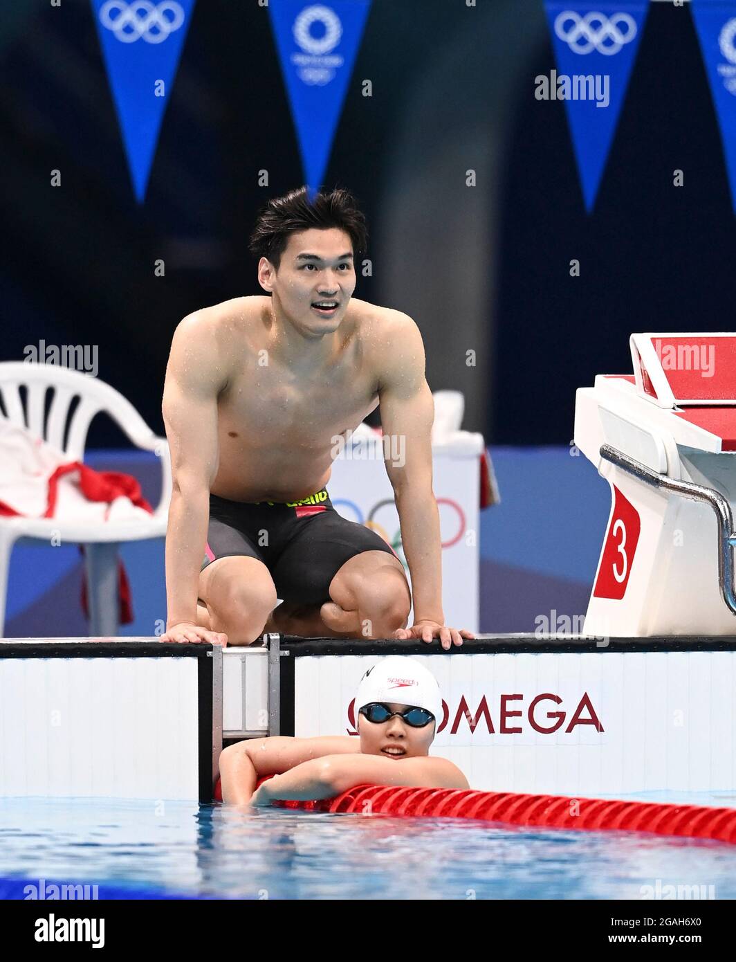 Tokyo, Japan. 31st July, 2021. Xu Jiayu (top) and Yang Junxuan of China reacts after the mixed ...
