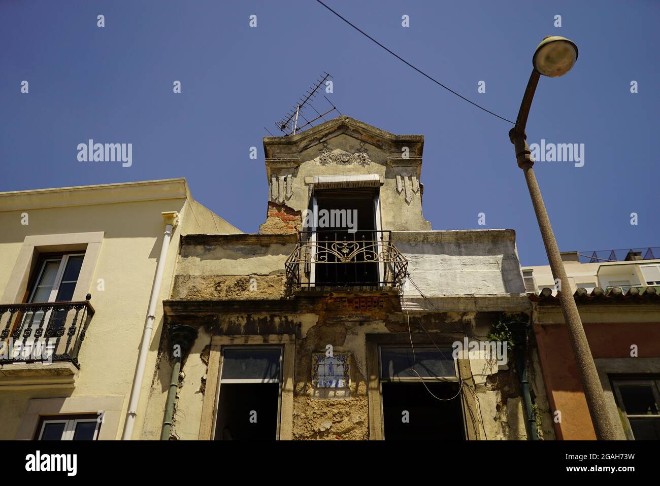 Low angle shot of balcony of an old building against a blue sky Stock ...