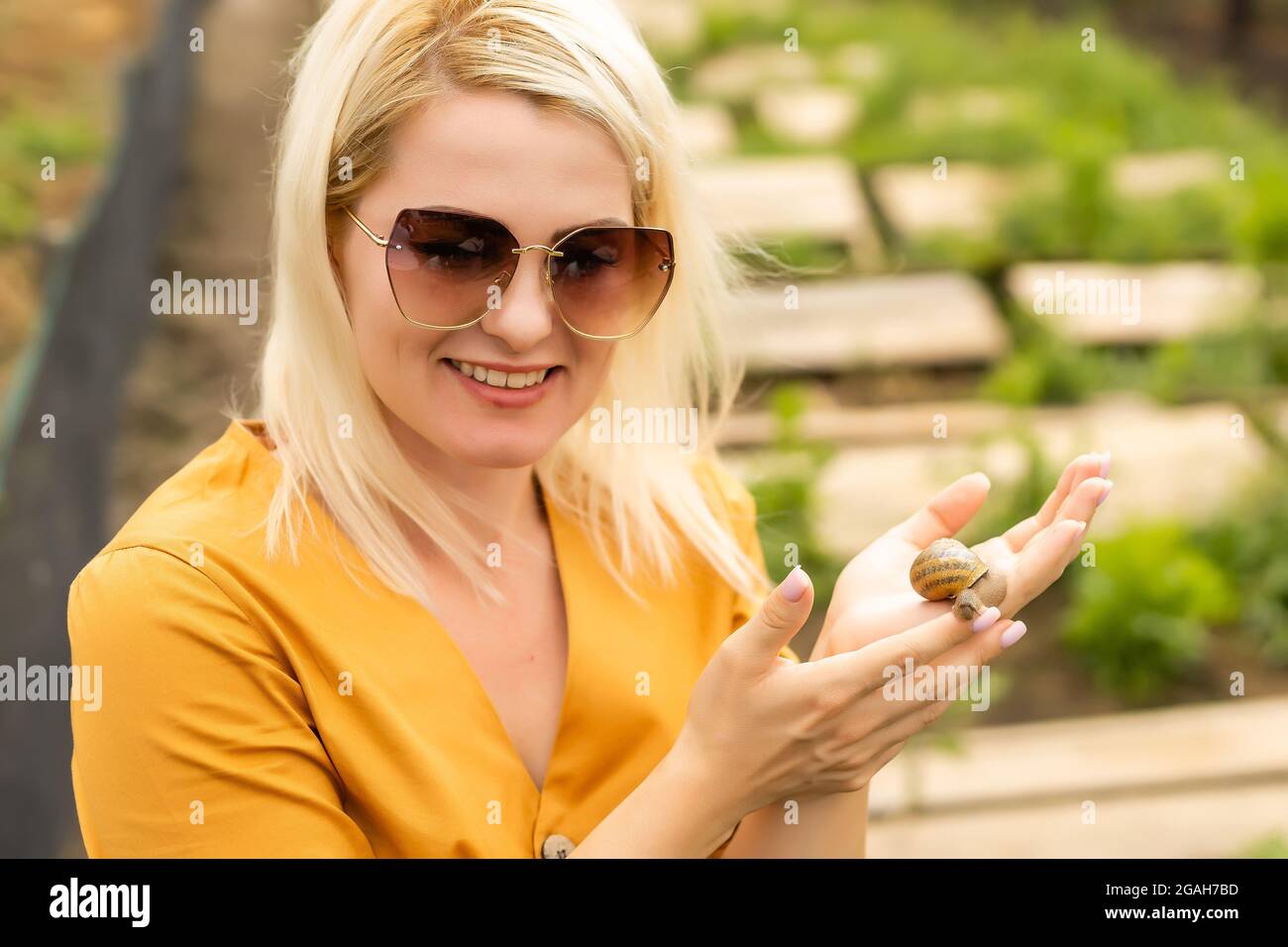 snail sitting on a woman's hand Stock Photo - Alamy