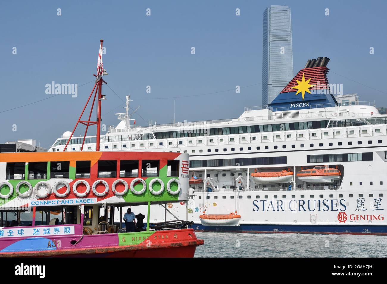 The star ferry boat and the cruise ship are seen at Victoria harbor in ...