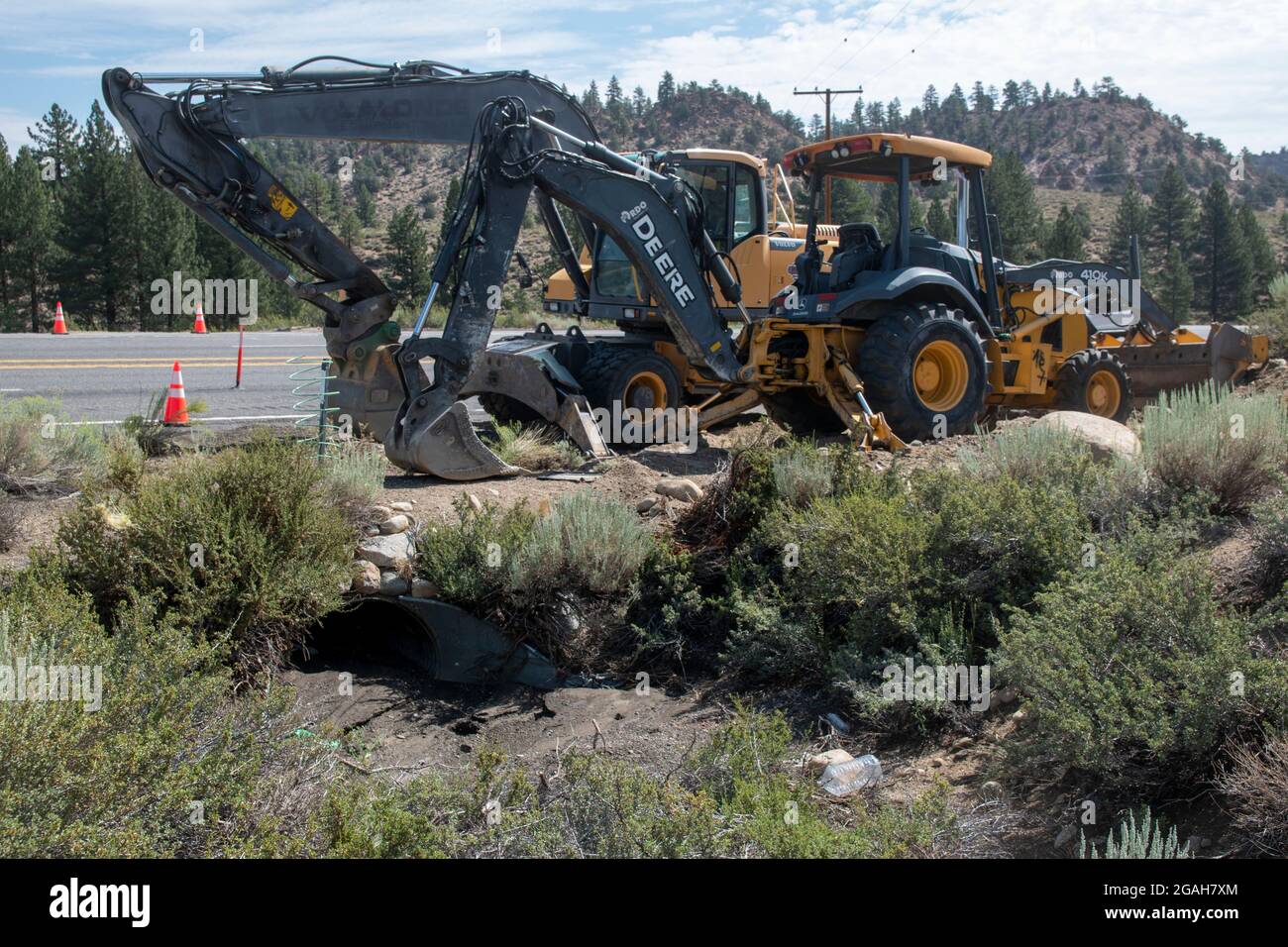 These excavators sit on the side of a highway on Sherwin Grade in Mono ...