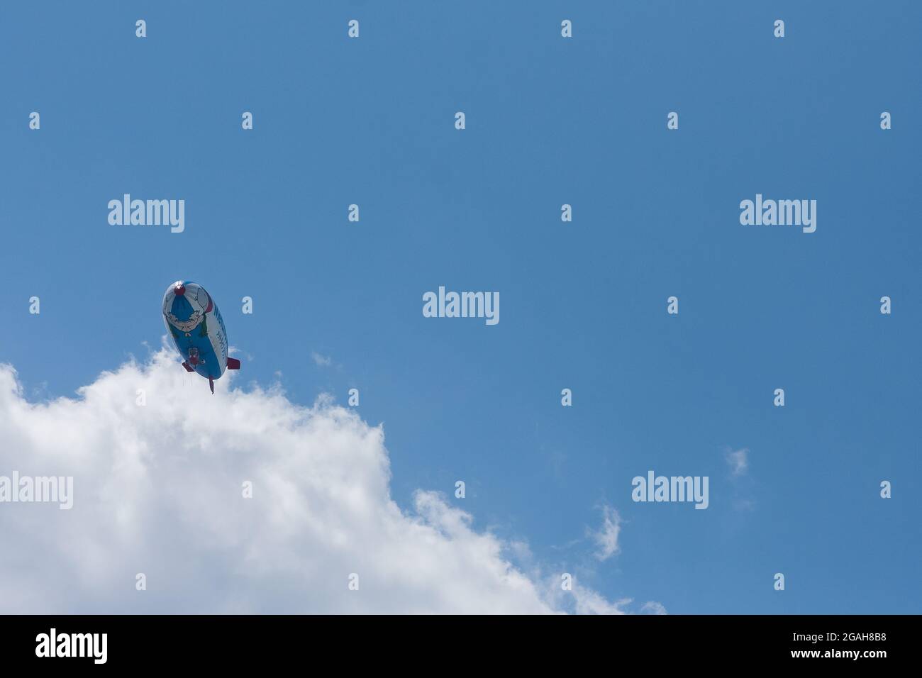 The MetLife Snoopy Zeppelin airship or blimp flying over Tokyo, Japan ...