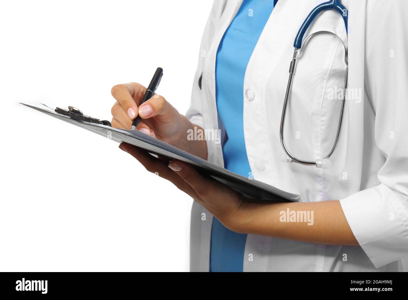 Smiling medical doctor writing in a folder, isolated on white, close-up ...
