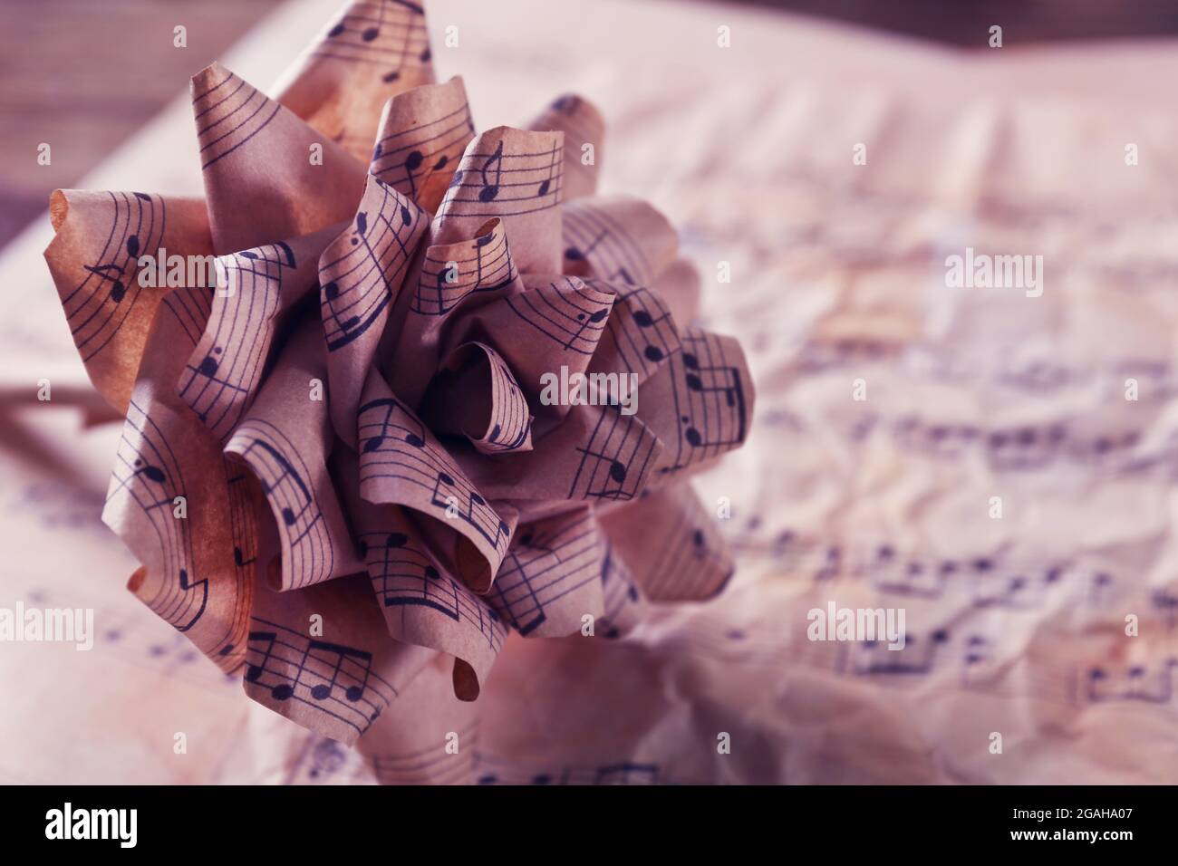 Beautiful paper-made rose on musical notes page background Stock Photo ...