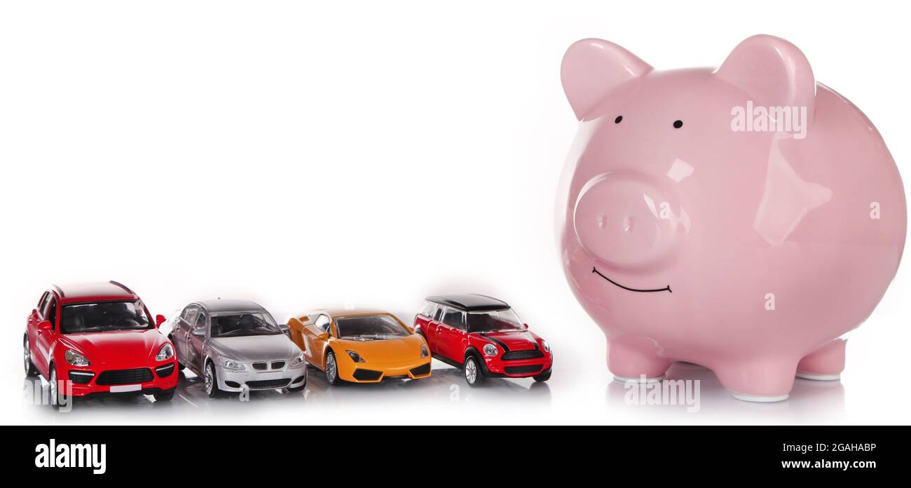 Pig moneybox and toy cars isolated on white Stock Photo - Alamy