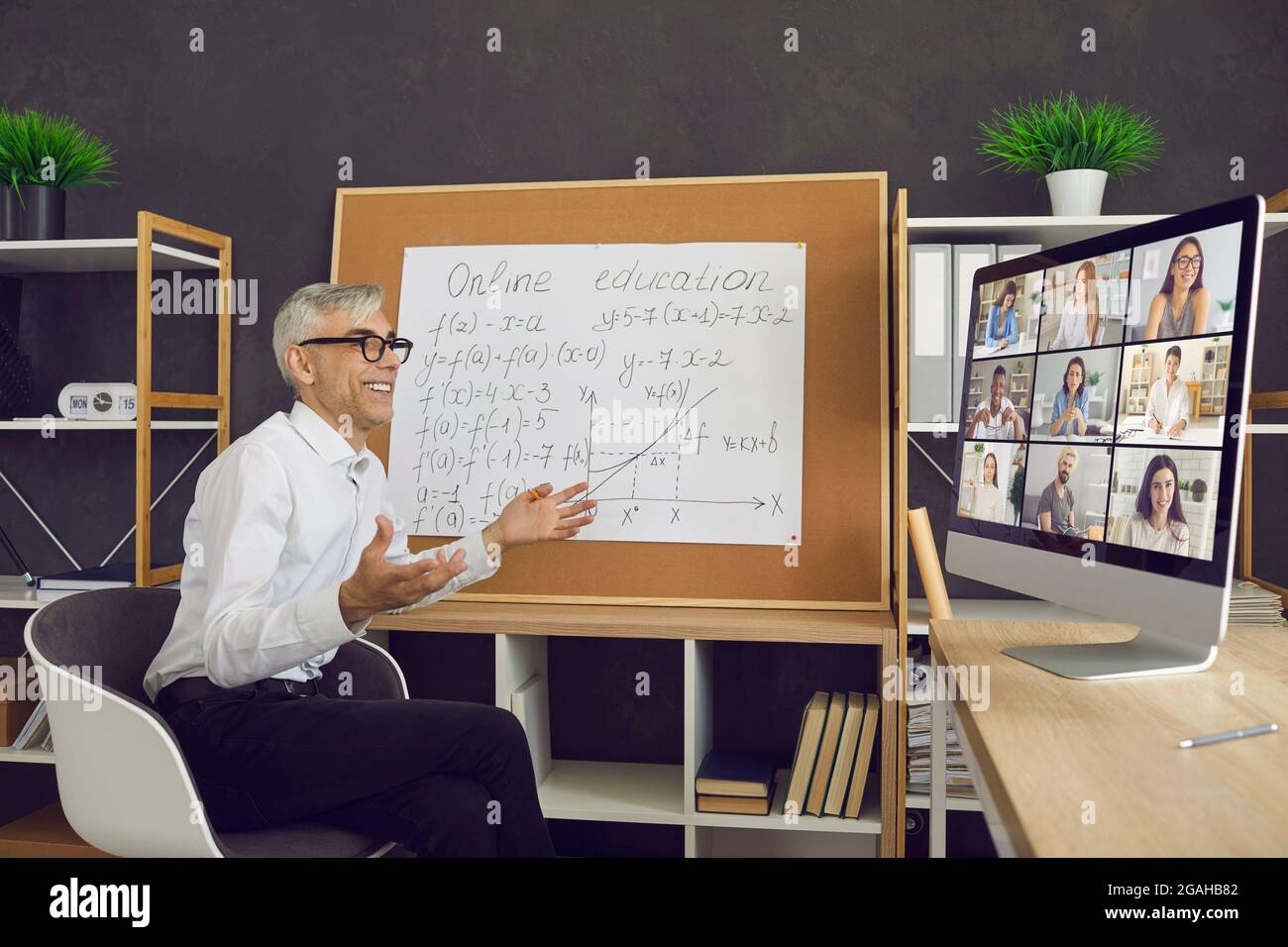 Teacher having an online math class with a group of college students ...