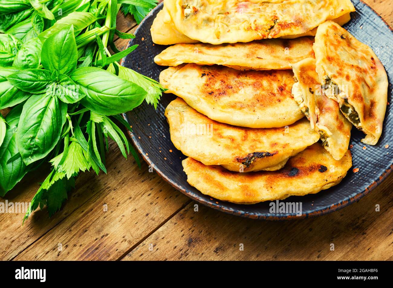 Unleavened dough pie stuffed with fresh herbs. Qutabs or kutab ...