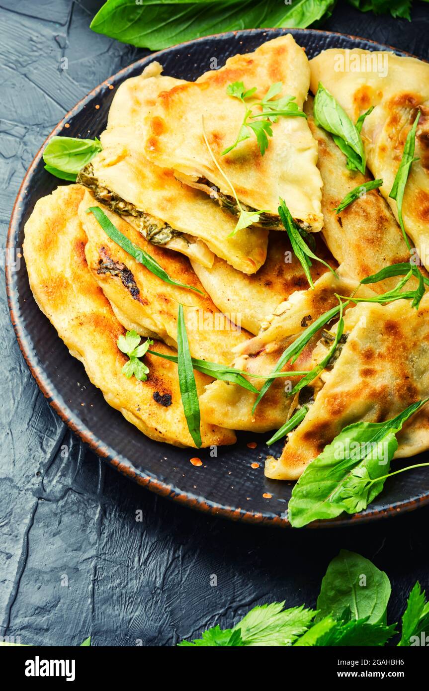 Pie stuffed with spring greens and cheese. Homemade qutabs or kutab ...