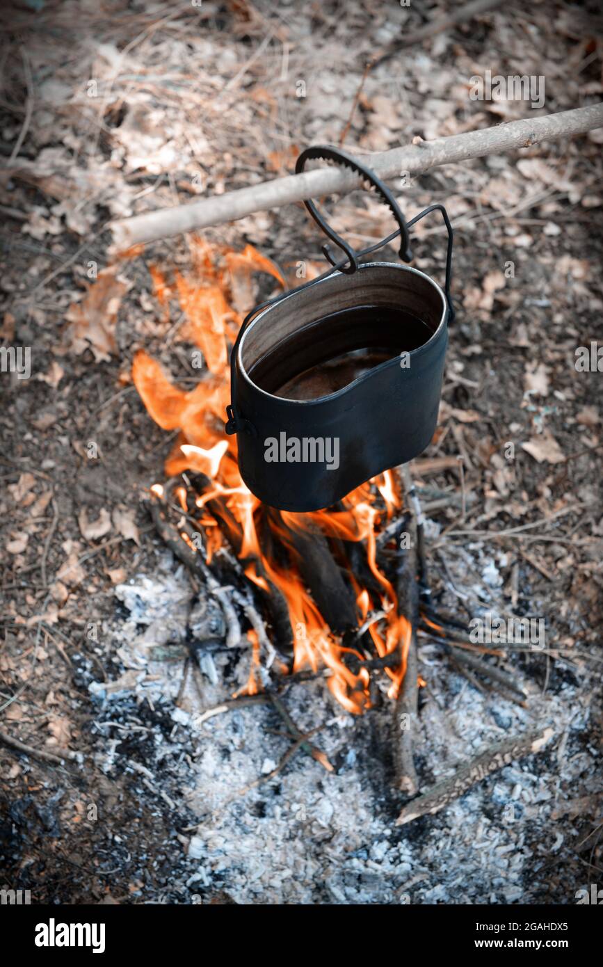 Kettle on fire in the forest Stock Photo - Alamy