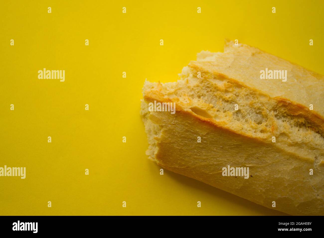 Bread with copy space on yellow background Stock Photo - Alamy