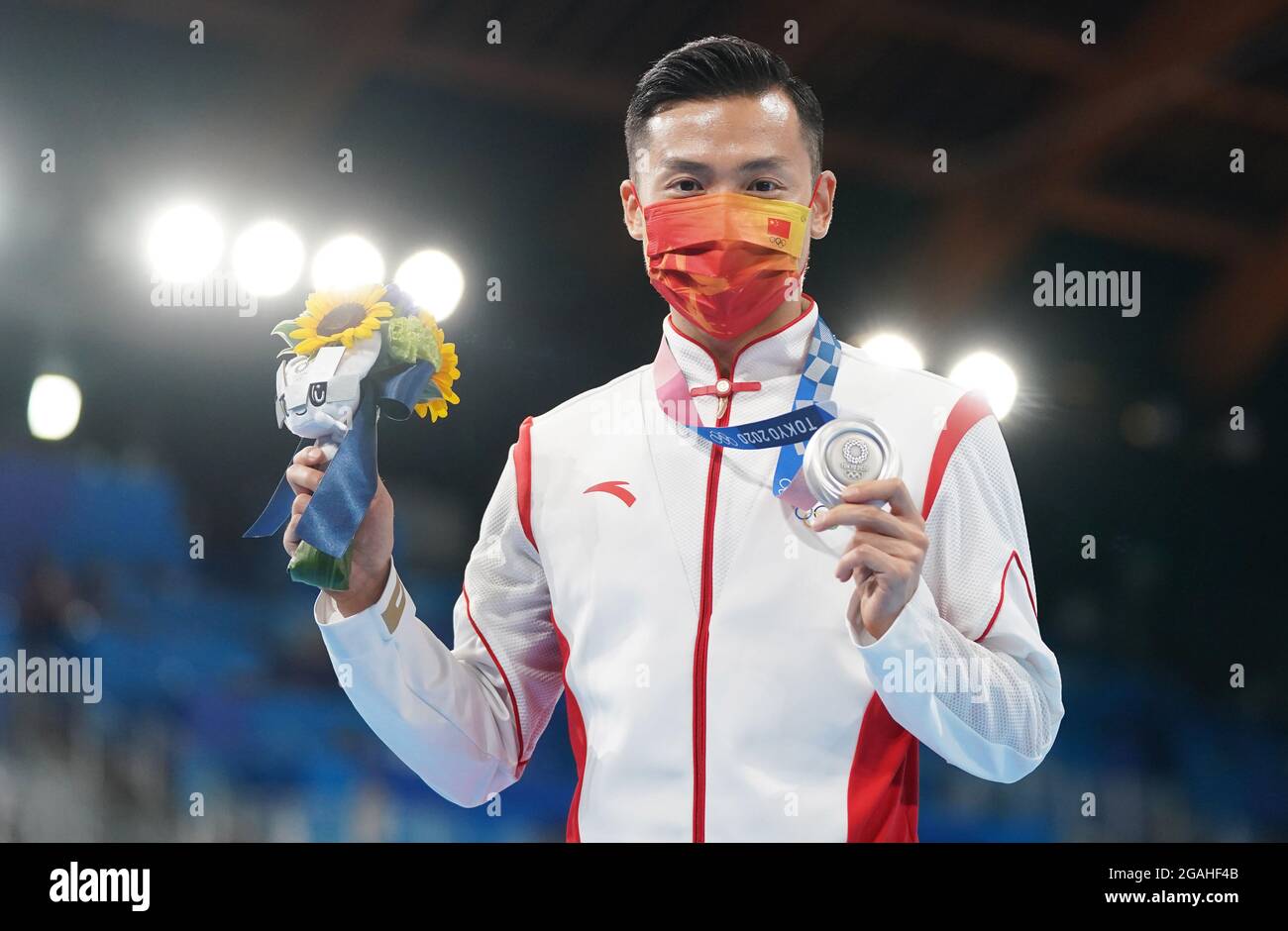 Tokyo, Japan. 31st July, 2021. Dong Dong of China shows his medal after ...