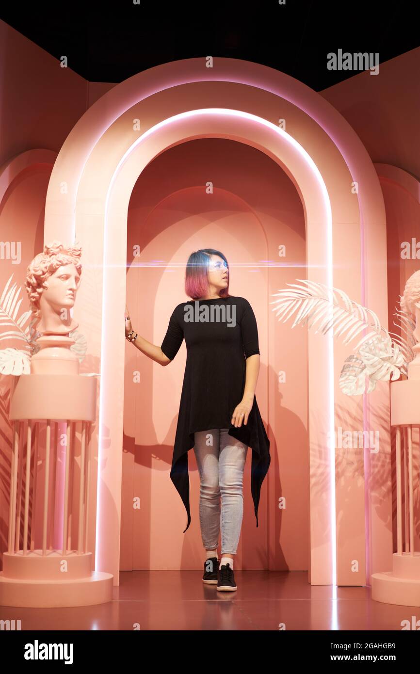 Beautiful women in cyber futuristic style is teleporting to destination ...