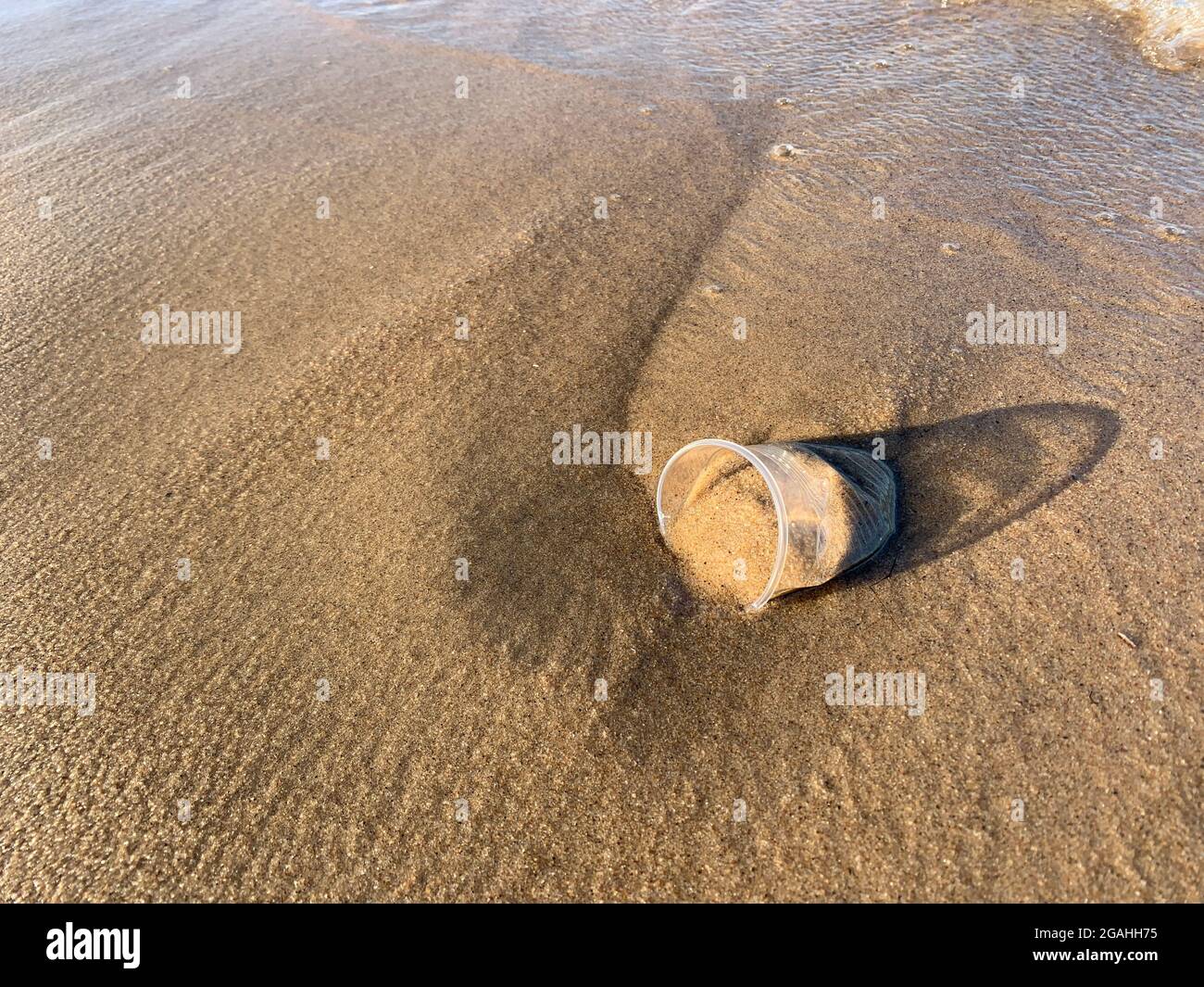 Close up of plastic cup in the water. Plastic pollution concept Stock ...