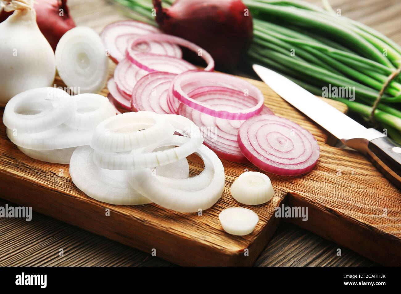 Composition of onions and garlic on wooden background, close up Stock ...