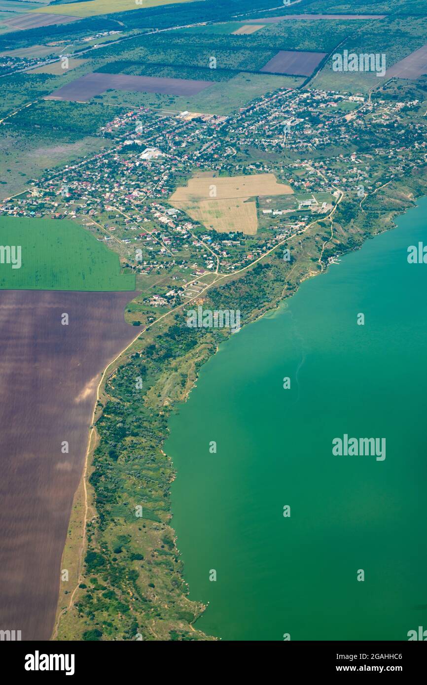 Land view through the airplane window. Fields, roads, rivers from a ...