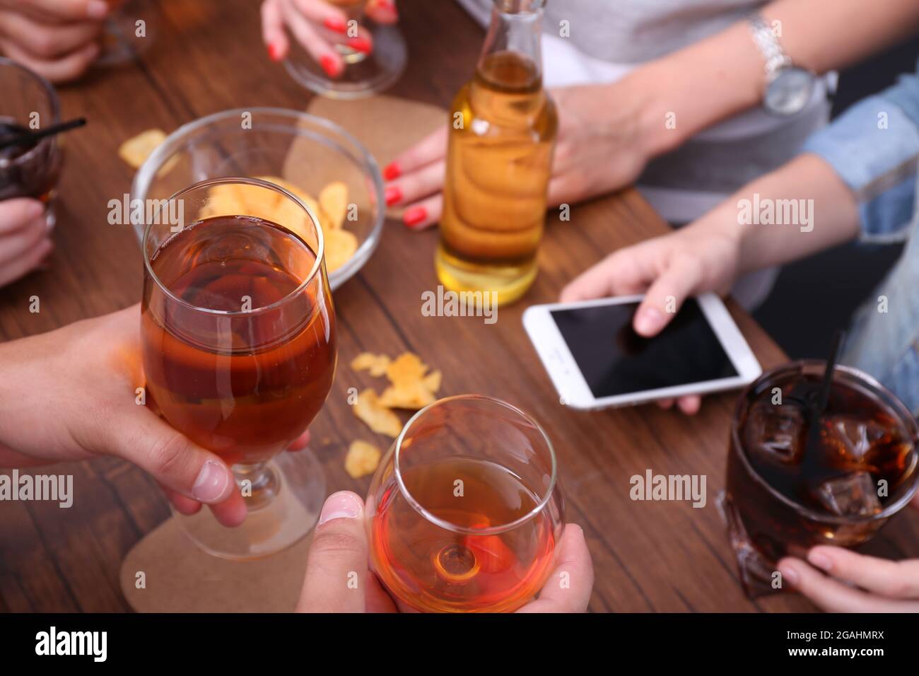 View on friends having alcoholic drinks in the bar, close-up Stock ...