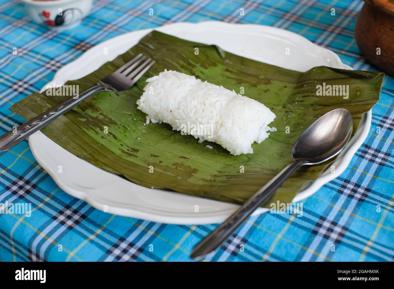 steamed rice with banana leaf spoon and folk on a dish Stock Photo - Alamy