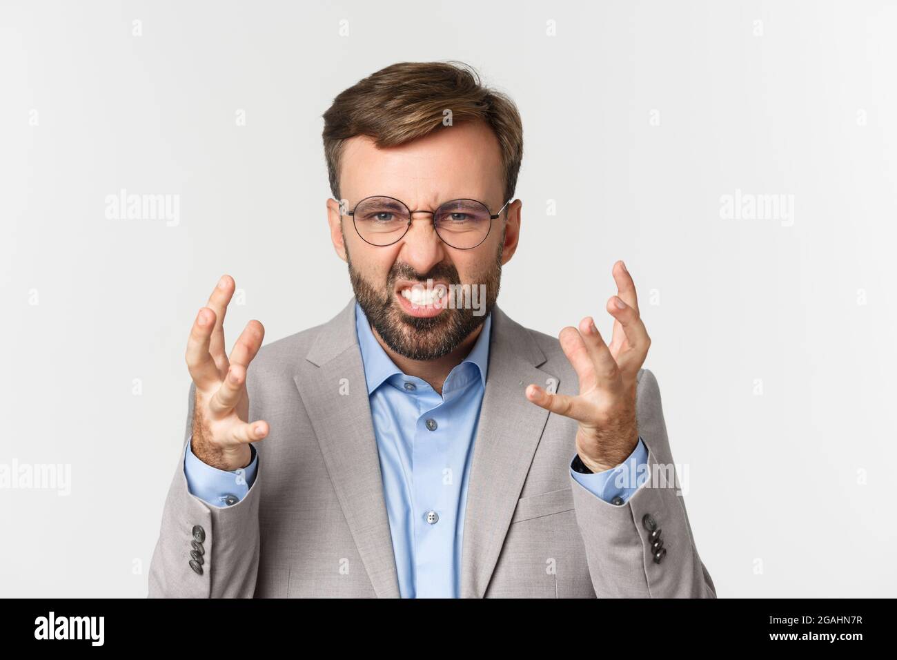 Close-up of angry businessman in gray suit and glasses, shaking hands ...