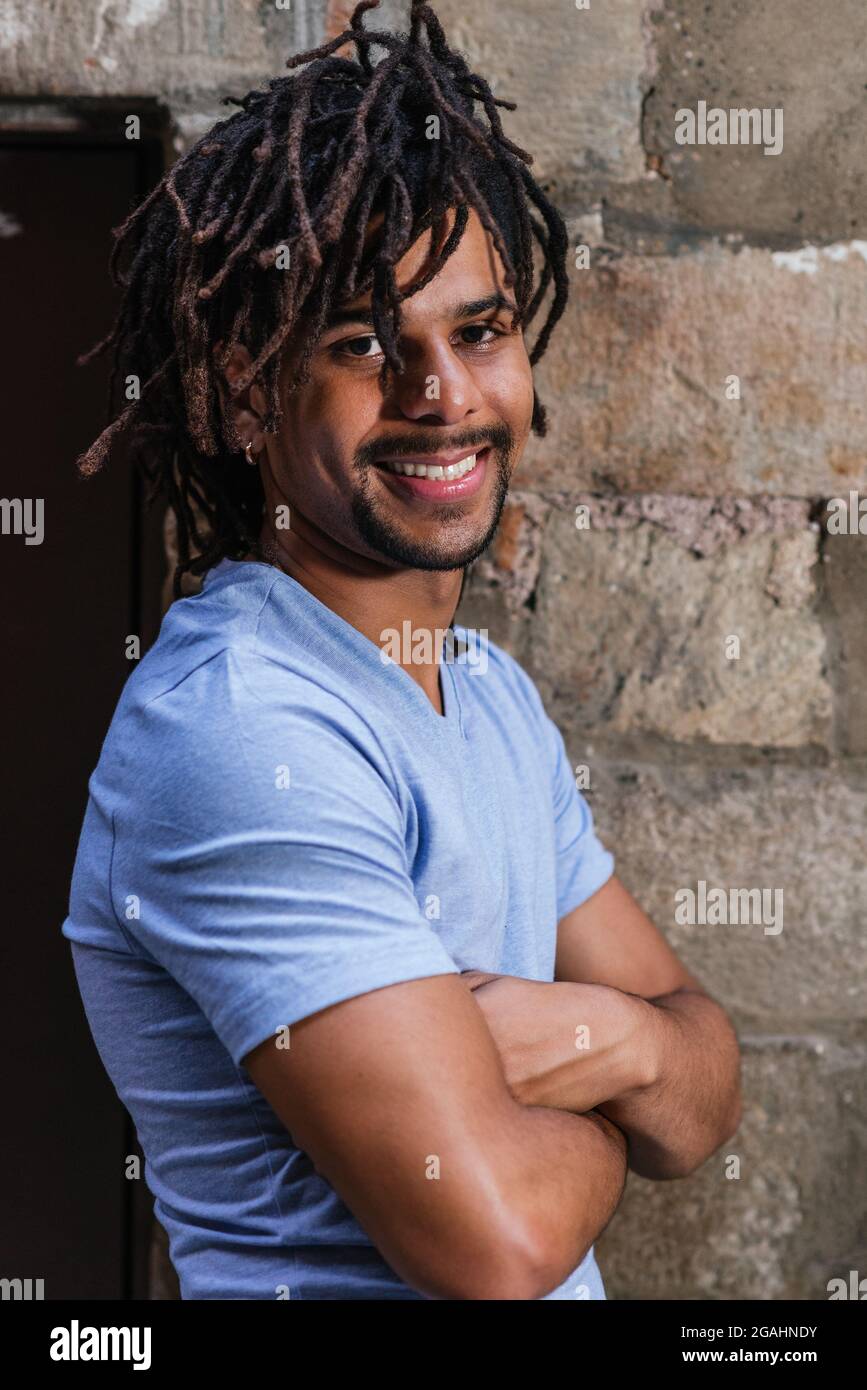 vertical portrait of an attractive latin american man. He wears ...