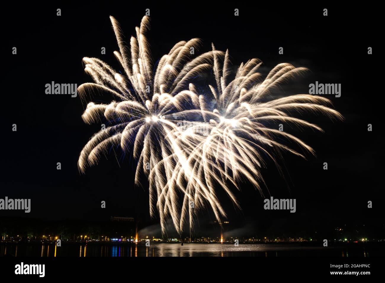 Beautiful fireworks show on a lake Stock Photo - Alamy