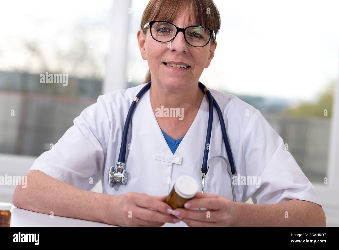 Portrait of mature female doctor checking medicine Stock Photo - Alamy
