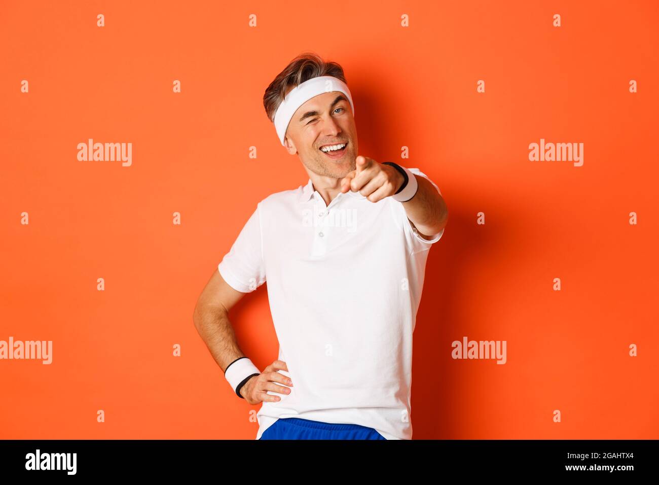 Mature winking man pointing hi-res stock photography and images - Alamy