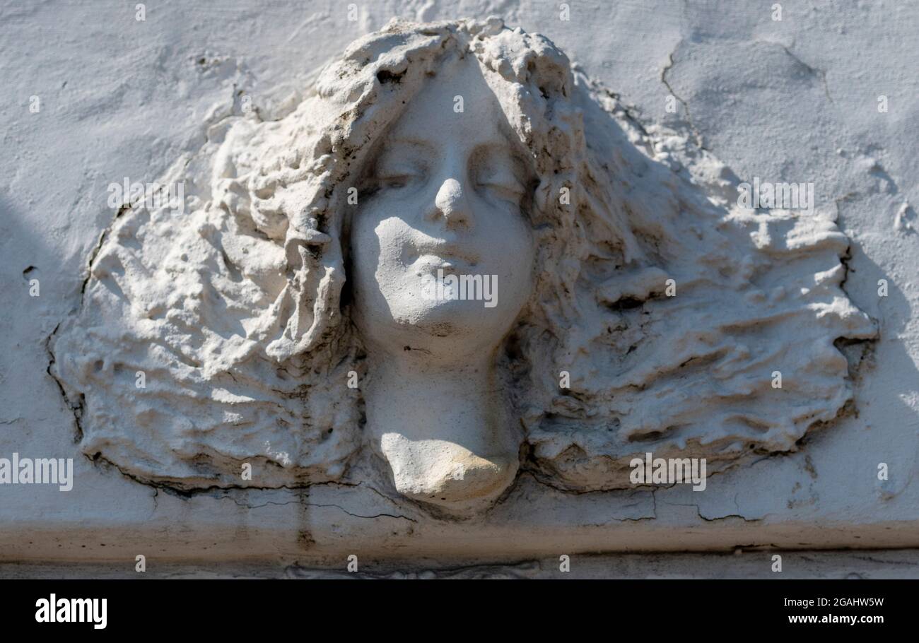 plaster stone gargoyle, womans head in relief, plaster building ...
