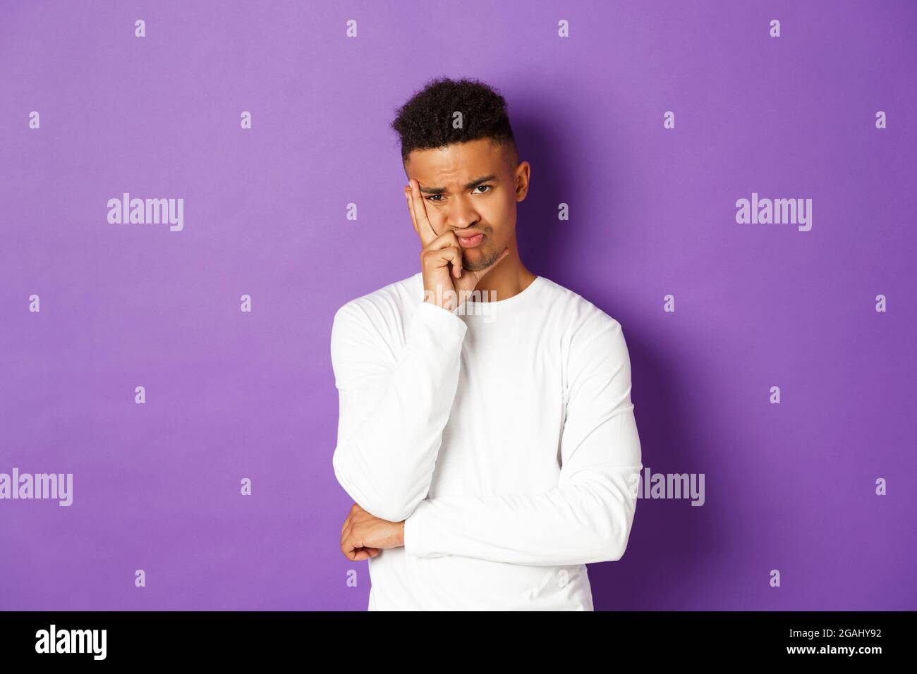 Portrait of disappointed and gloomy african-american man, leaning face ...