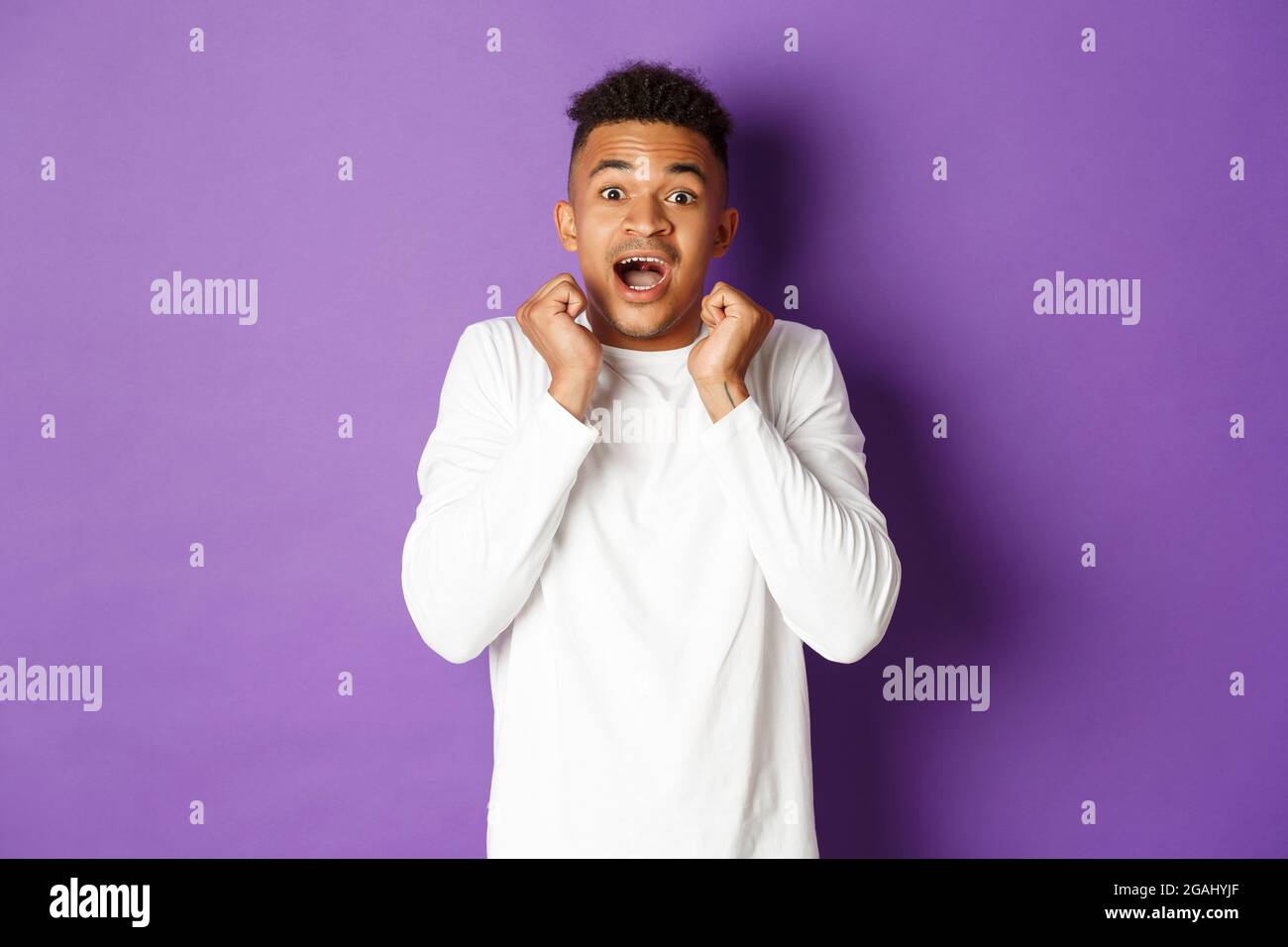 Portrait of astonished african-american guy in white casual shirt, open ...