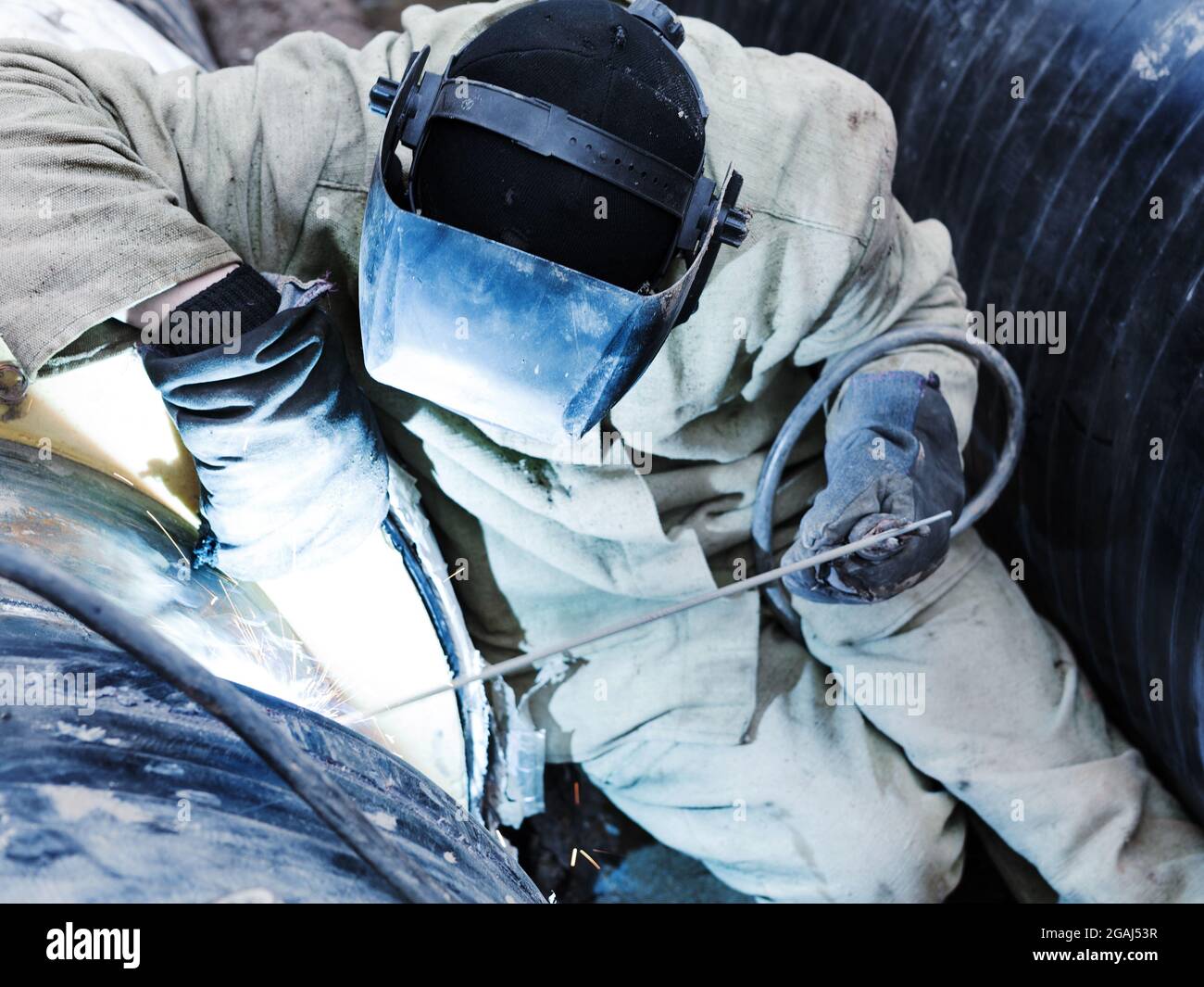 Repair of heating duct. The workers, welders made by electric welding ...